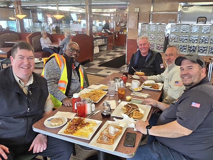 A gathering of friends proving that the best business meetings happen over plates of pancakes and endless coffee refills.