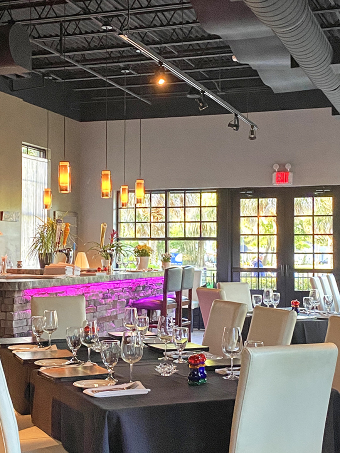 Modern elegance defines the space, with amber pendant lights casting a warm glow over tables set for memorable meals and conversations worth having.