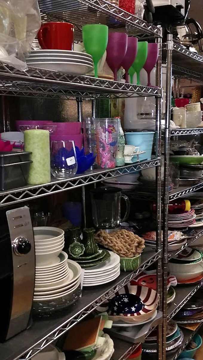 Colorful glassware and pristine white plates stacked with precision&mdash;proof that someone else's kitchen cleanout becomes your entertaining upgrade.