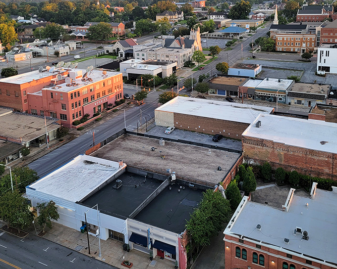 Sunset casts a golden glow over Meridian's downtown rooftops, highlighting the blend of historic charm and modern amenities that make retirement here so appealing.
