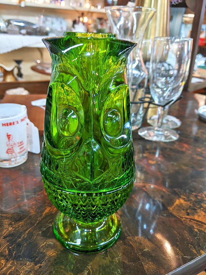 This emerald glass owl vase stares with hypnotic eyes, daring you to walk away without adopting this mid-century conversation piece for your sideboard.