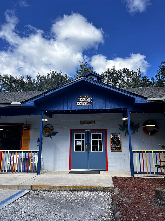 The entrance says it all: "FRESH CRABS" and a rainbow railing. Like walking into your most colorful seafood dreams with both eyes open.