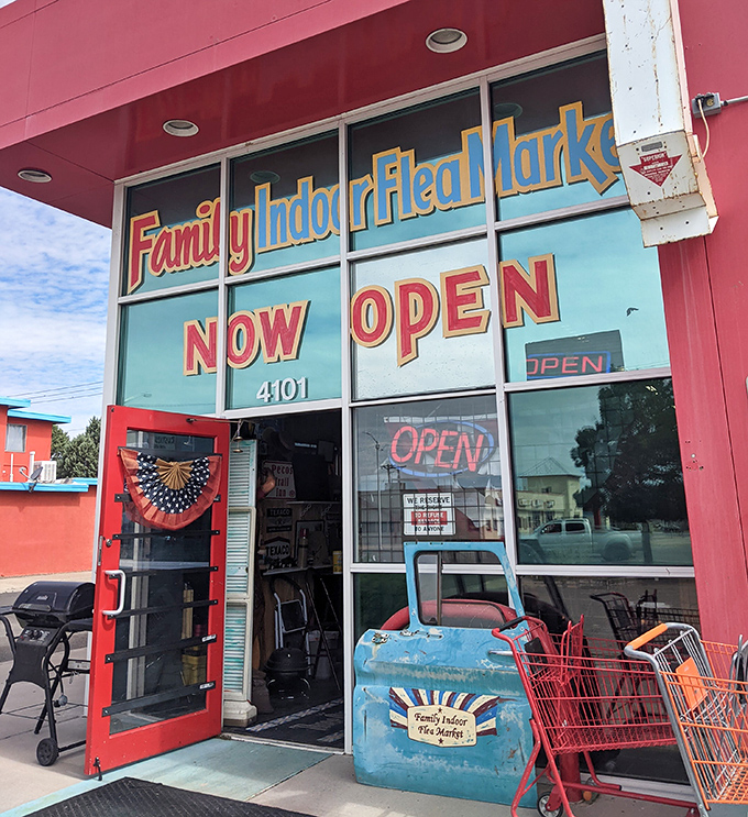 The welcoming entrance with its vibrant red frame and vintage shopping cart says, "Come in, stay awhile, and find something you didn't know you needed."