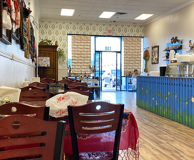 The dining area's vintage wallpaper and wooden accents make you feel like you've discovered a secret spot that time forgot.