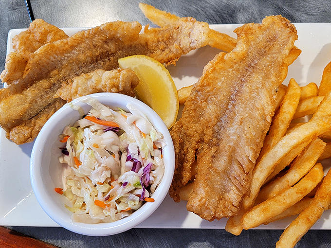 Lake Erie walleye fried to golden perfection with crispy fries and fresh coleslaw&mdash;a Great Lakes trifecta that never disappoints.