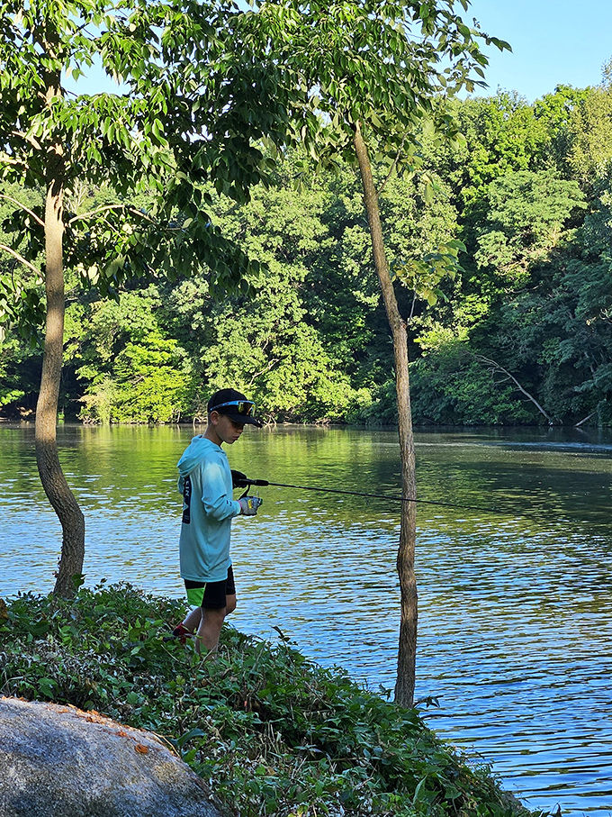 The shoreline angler demonstrates that fishing isn't just about catching – it's about connecting with water, wilderness, and wonder.