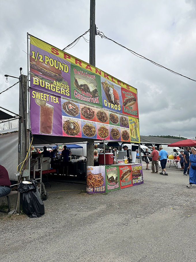 The food stall banner promises half-pound burgers and gyros – fuel for serious shoppers navigating acres of potential purchases.