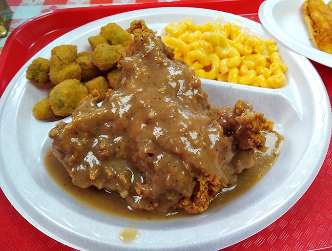 Southern comfort on a compartment plate: crispy fried chicken under savory gravy, mac and cheese that glows like Tennessee sunshine.