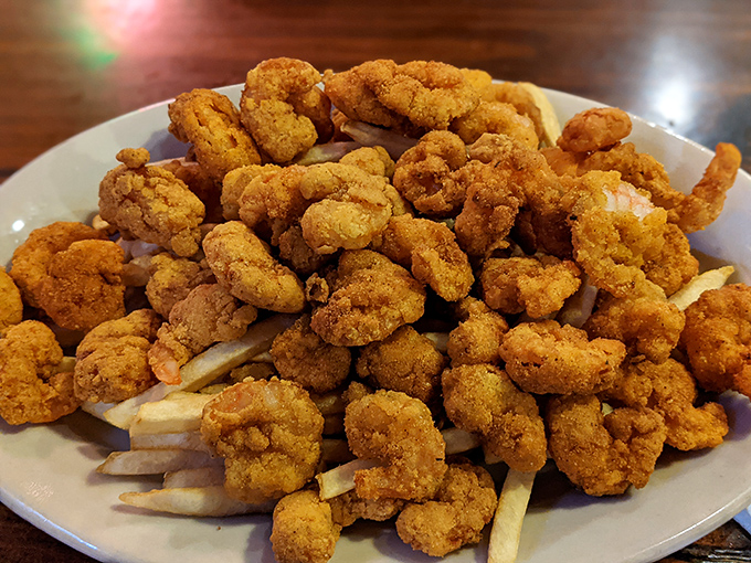 A mountain of golden fried shrimp that makes French fries hide in shame. Crispy perfection that demands a squeeze of lemon.