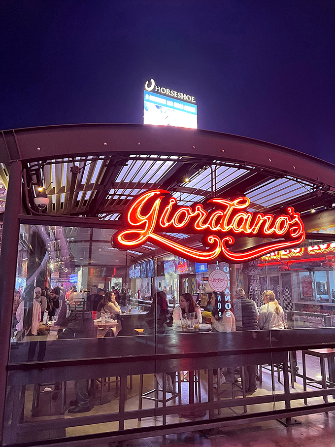 As night falls, Giordano's neon sign becomes part of Vegas' famous lightscape. Pizza pilgrims know to follow the glow.
