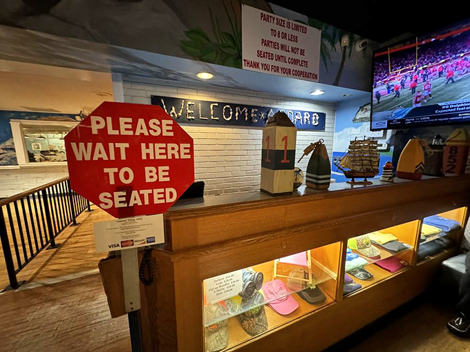 The entrance area&mdash;where anticipation builds and hunger deepens. That "Please Wait" sign might as well say "Prepare for Deliciousness Ahead."