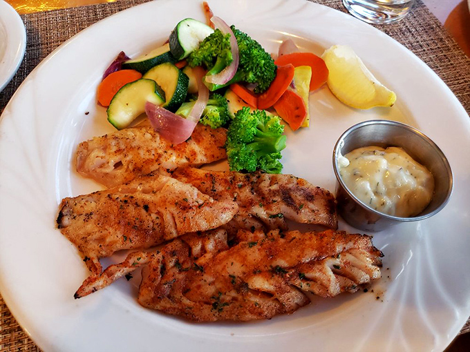 Simple perfection: grilled fish that tastes like it jumped from ocean to grill to plate, with vegetables so fresh they practically introduce themselves.