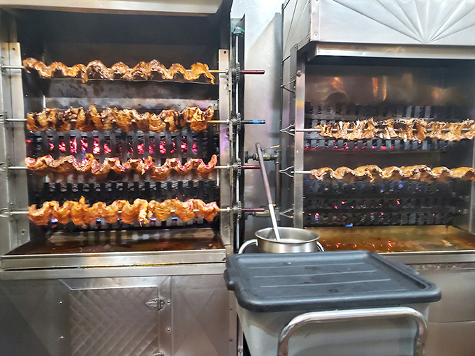 The rotisserie in action&mdash;where chickens perform their hypnotic carousel dance before becoming the star of someone's dinner plate. Mesmerizing and mouth-watering simultaneously.