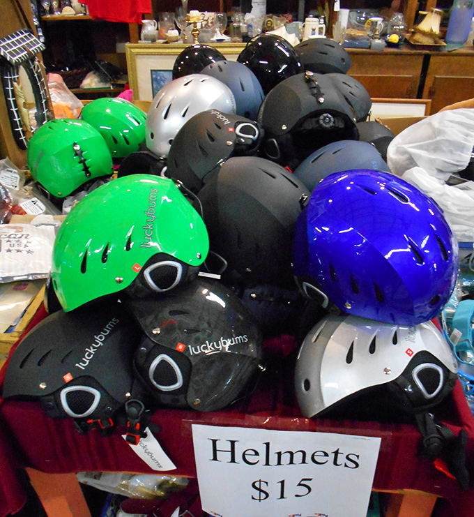 "Helmets $15" reads the sign above a colorful pile of protective headgear&mdash;because even your safety equipment can make a style statement.