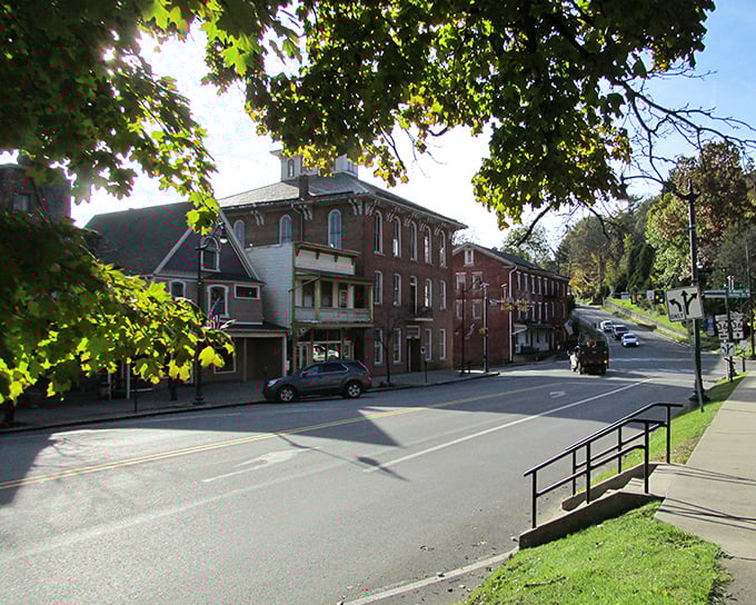 Sunlight filters through mature trees onto Brookville's historic district, creating the kind of dappled glow that real estate agents charge extra for.