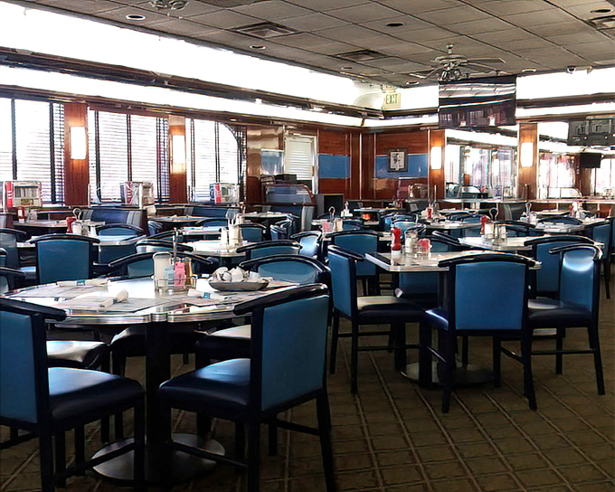 The blue booth section offers a quieter corner for those morning philosophical discussions about whether the home fries or hash browns reign supreme.