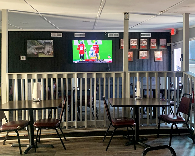 The navy blue walls and wooden railings create the perfect backdrop for what's about to be the messiest, most satisfying meal of your week.