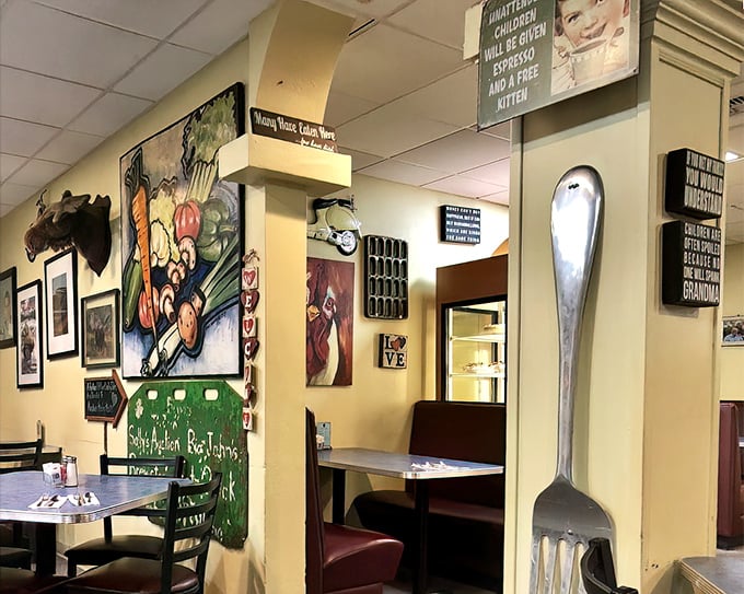 Every inch of wall space celebrates food, family, and slightly sassy kitchen wisdom. That giant fork isn't subtle about the priorities here.