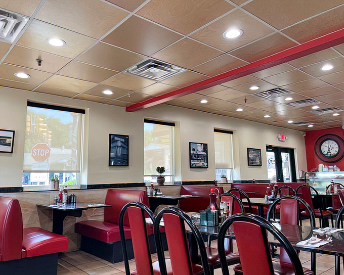 The dining room's red accents and clean lines create an atmosphere where conversation flows as freely as the coffee.
