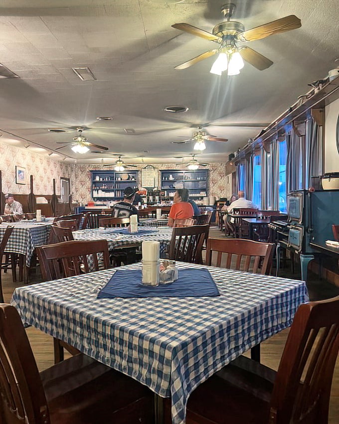 The evening light bathes the dining room in nostalgia. Each checkered tablecloth tells a story of celebrations, road trips, and pie-induced happiness.