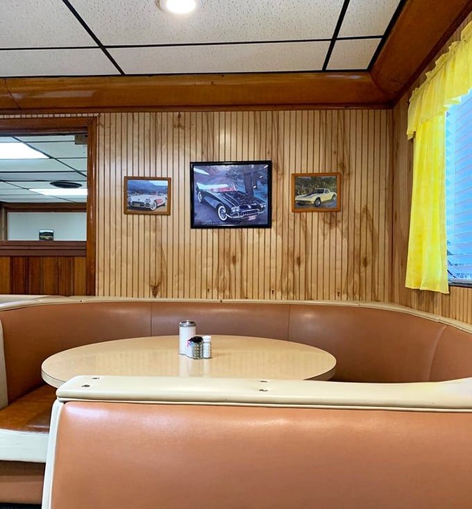Wood-paneled walls adorned with classic car photos create that perfect nostalgic atmosphere for enjoying food that tastes like memories.