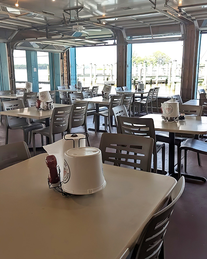 Garage doors open to let the bay breeze mingle with seafood aromas. This indoor-outdoor space captures the essence of casual coastal dining.