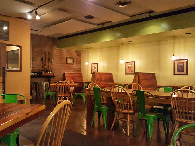 The hostess stand with that vintage wallpaper sets the tone before you even see a menu or smell the garlic.