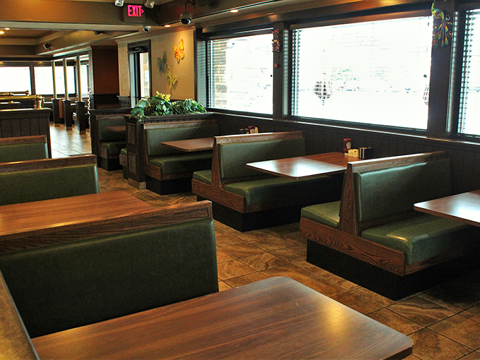 Green booths lined up like soldiers ready for the breakfast battle. The real war? Your willpower versus their portion sizes.