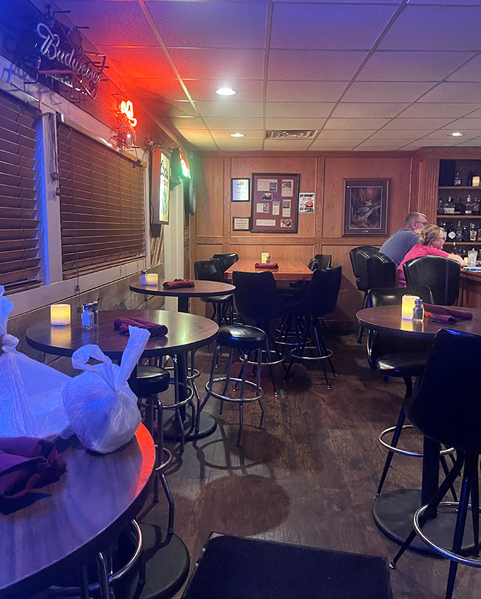 Neon beer signs and cozy booth seating create the kind of atmosphere where everyone becomes a regular eventually.