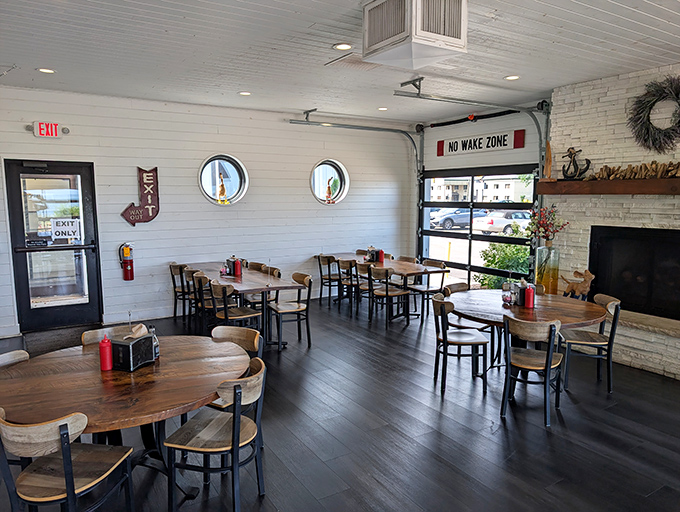 Porthole windows and wooden tables create a dining room that feels like the captain's quarters of a particularly delicious ship. Nautical, but nice.