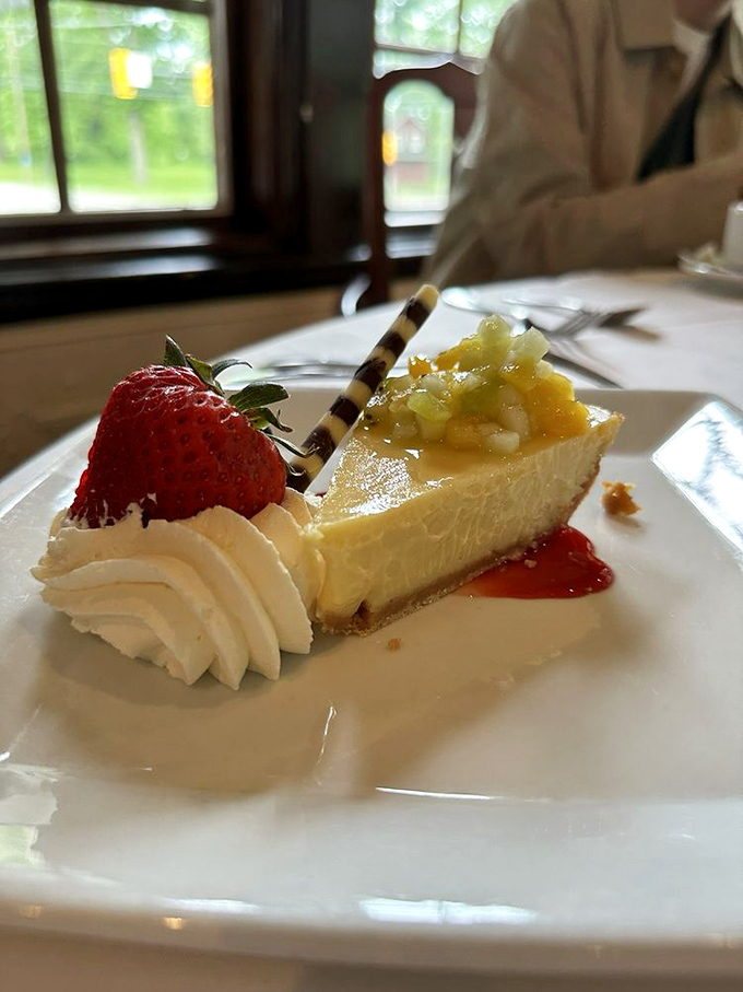 A slice of key lime pie that strikes the perfect balance between tart and sweet, with a dollop of whipped cream and fresh strawberry for that extra touch.