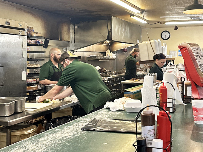 Behind-the-scenes magic where smoke meets meat. The kitchen crew orchestrates a symphony of flavor with practiced precision.