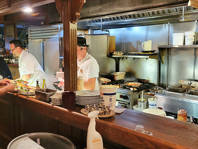 The kitchen's choreographed chaos reveals the alchemy behind Henry's legendary seafood &ndash; where fresh ingredients meet culinary expertise.