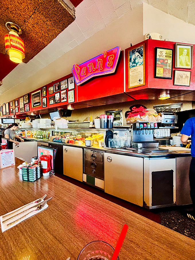Behind the counter, where magic happens&mdash;the neon Pann's sign glowing like a beacon of hope for the hungry and caffeine-deprived.