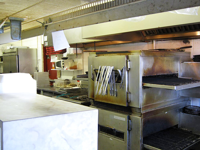 Behind the scenes where smoke meets meat. The well-worn equipment speaks of countless racks of ribs that have emerged transformed and glorious.