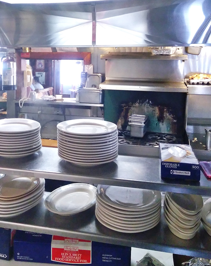 The kitchen pass&mdash;where breakfast magic happens. Those stacked plates aren't just dinnerware; they're blank canvases awaiting their egg-and-pancake masterpieces.
