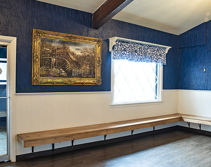 Elegant framed artwork against navy blue walls&mdash;because even comfort food deserves a touch of class now and then.