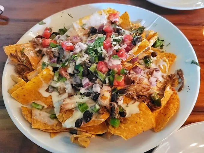 Nachos that don't mess around&mdash;crispy chips supporting a mountain of pulled chicken, black beans, and fresh veggies. A fiesta on a plate.