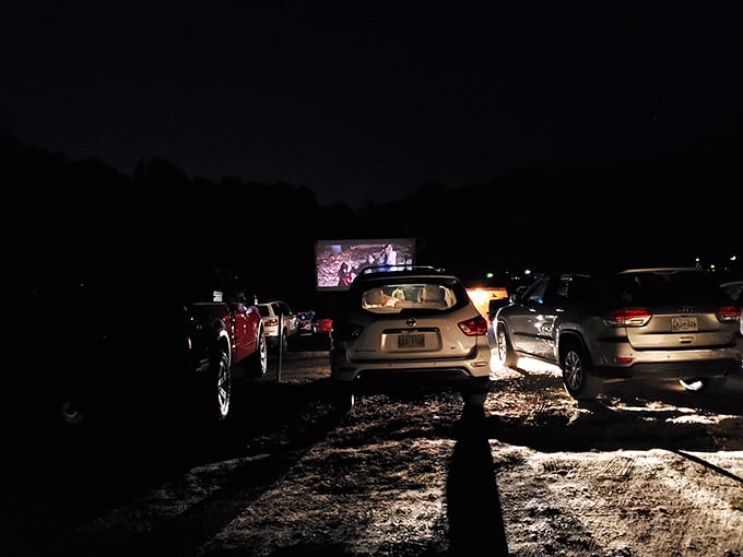 Headlights create an otherworldly glow as moviegoers settle in for the feature presentation.