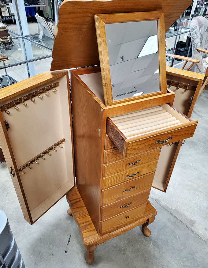 This oak jewelry armoire with its clever compartments and hidden drawers is practically furniture's answer to Mary Poppins' magical bag.