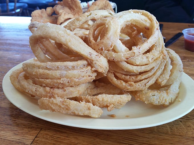 Onion rings stacked higher than a Jenga tower&mdash;crispy, golden hoops of joy that make you forget vegetables are supposed to be healthy.