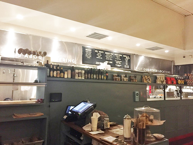 Behind the counter, where sandwich magic happens. The organized chaos of a busy deli kitchen has its own beautiful rhythm.