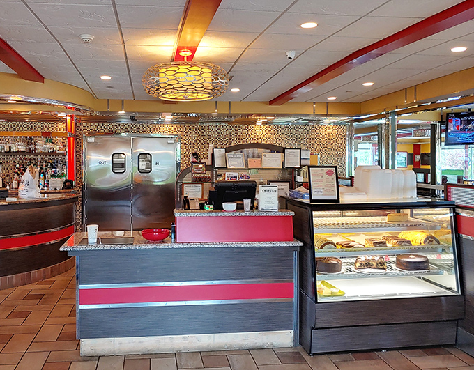 The host station doubles as temptation central, with a display case strategically positioned to ensure you never leave without dessert.