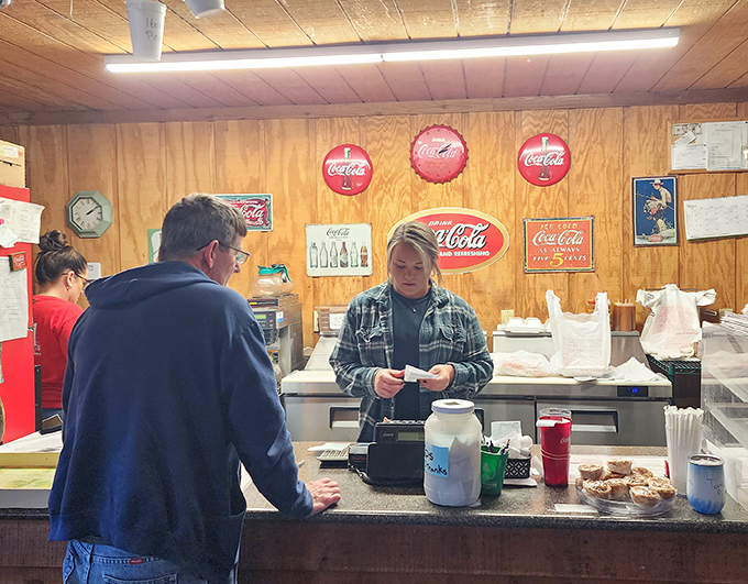 No fancy POS systems or digital menus here. Just real people taking orders the old-fashioned way, with Coca-Cola memorabilia watching approvingly.