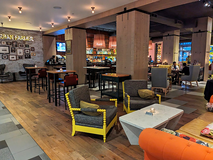 The lounge area says "stay awhile" in a way that makes you reschedule your afternoon plans. Yellow accents pop like flavor bombs.