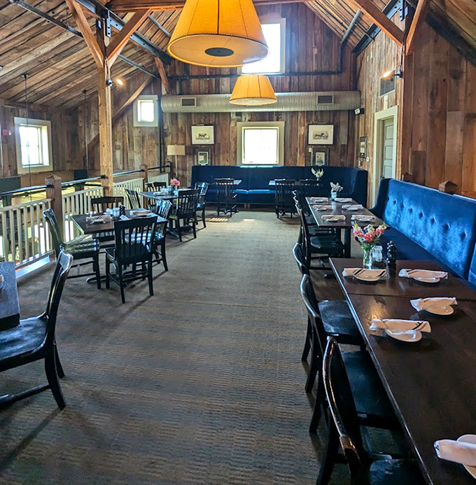 Rustic wooden beams, blue banquettes, and warm lighting create an atmosphere where memories are made between bites of exceptional food.