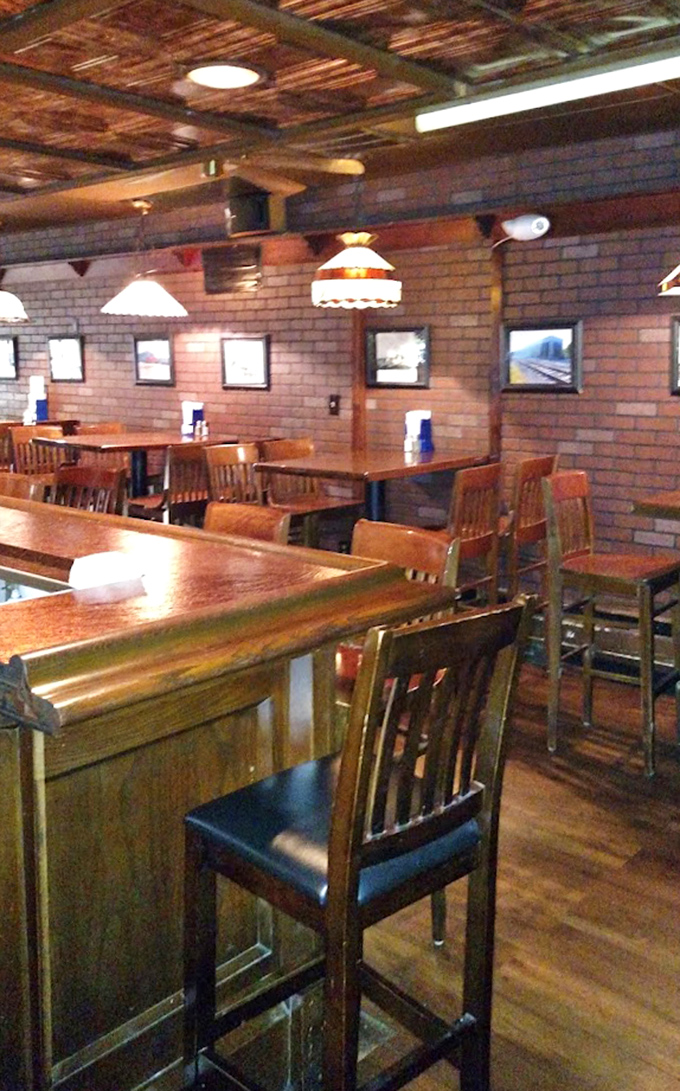 Wooden tables, brick walls, and pendant lighting create that perfect "third place" between home and work where life's simple pleasures reign supreme.