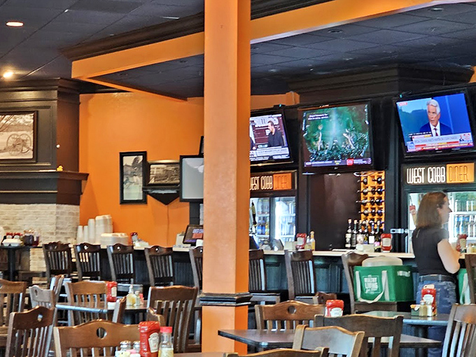 Orange walls, wooden chairs, and televisions create the perfect backdrop for food that demands your full attention.