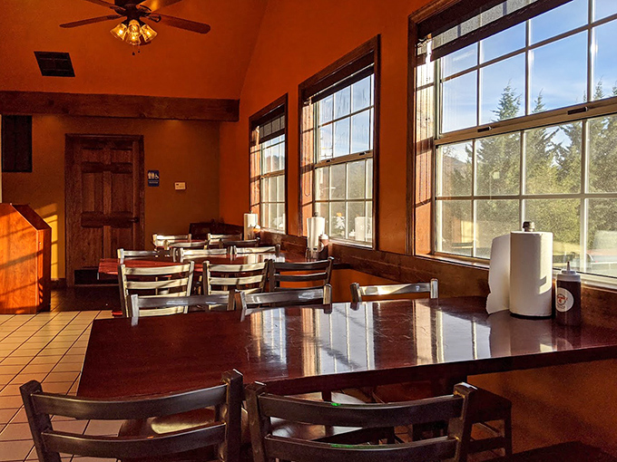 Sunlight streams through large windows, creating a warm, inviting dining space where the only thing better than the ambiance is the aroma of smoked meats.