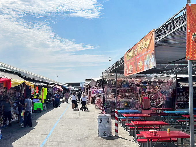 Sunlight bathes the bustling marketplace where families push strollers past vibrant stalls, hunting for deals with the determination of contestants on a shopping game show.